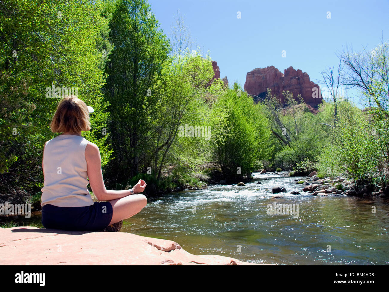 Woman meditating on a vortex point Oak Creek River Red Rock State Park ...