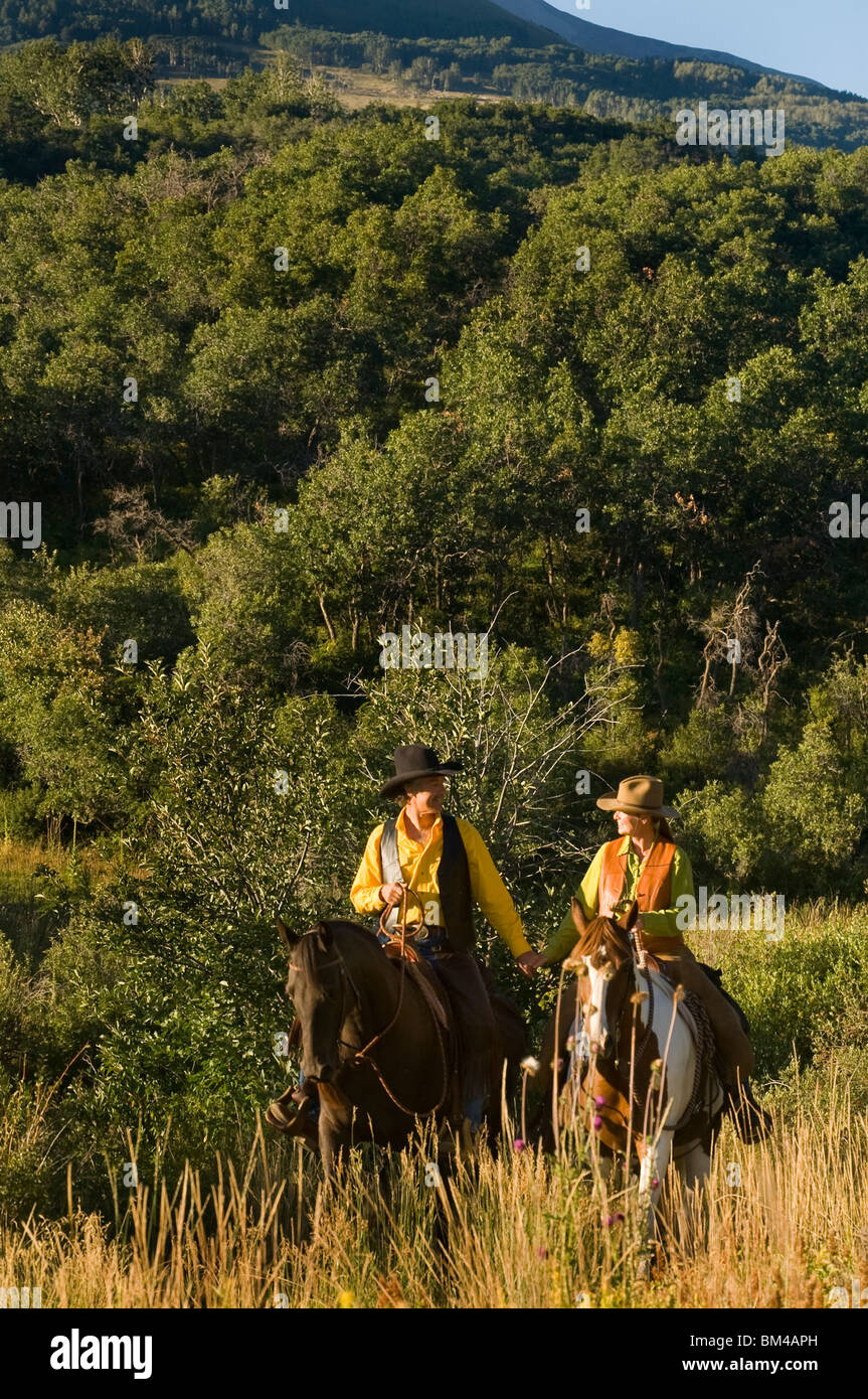 Couple riding horses Stock Photo - Alamy