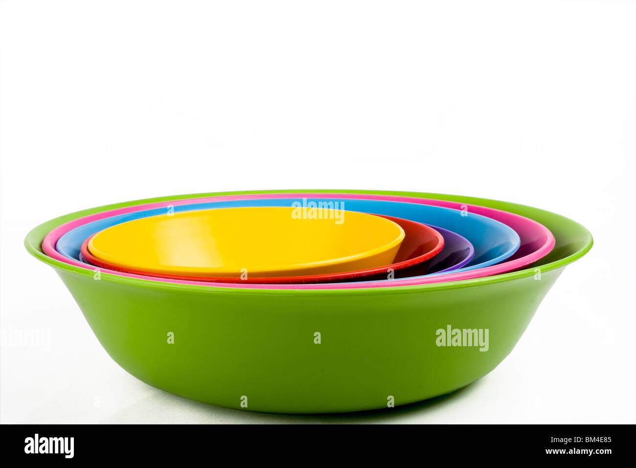 Stack of colorful plastic bowls over white background Stock Photo - Alamy