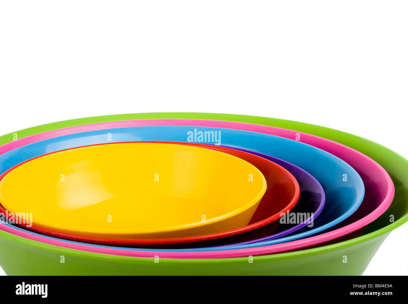 Stack of colorful plastic bowls over white background Stock Photo - Alamy