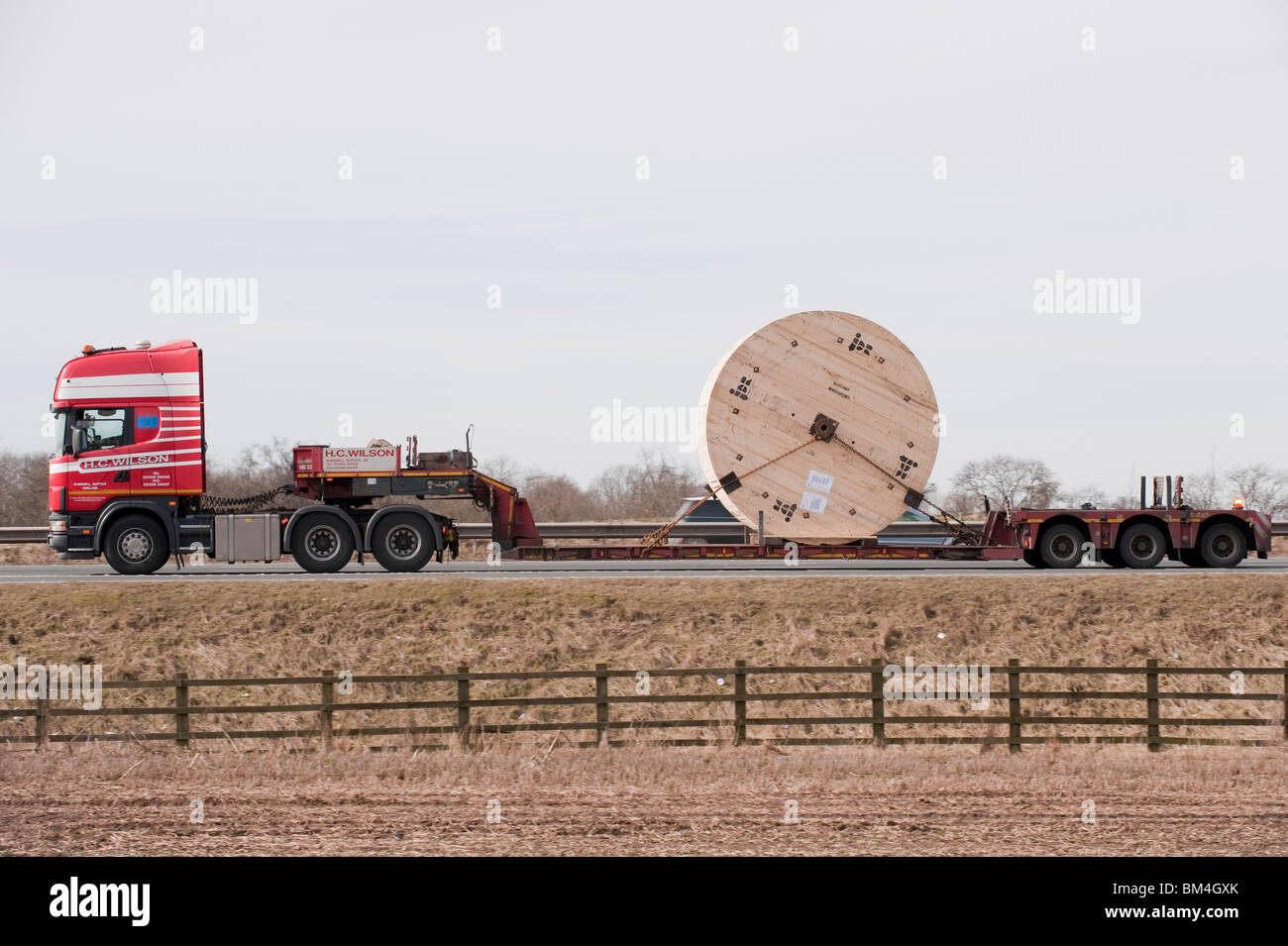 A low loader lorry travelling along a motorway Stock Photo - Alamy
