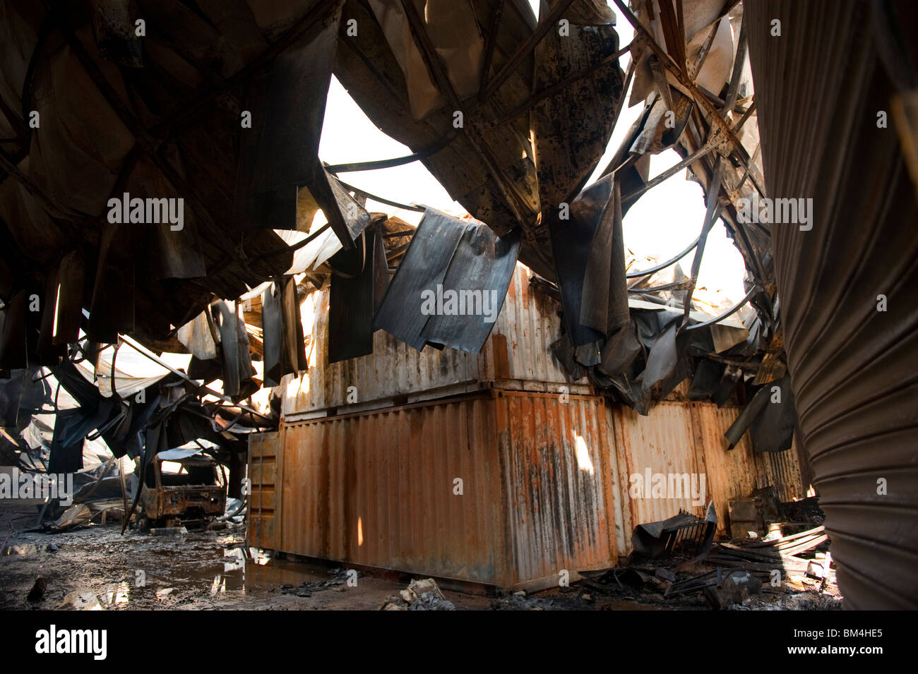 Large factory and warehouse collapsed and smoldering following major ...