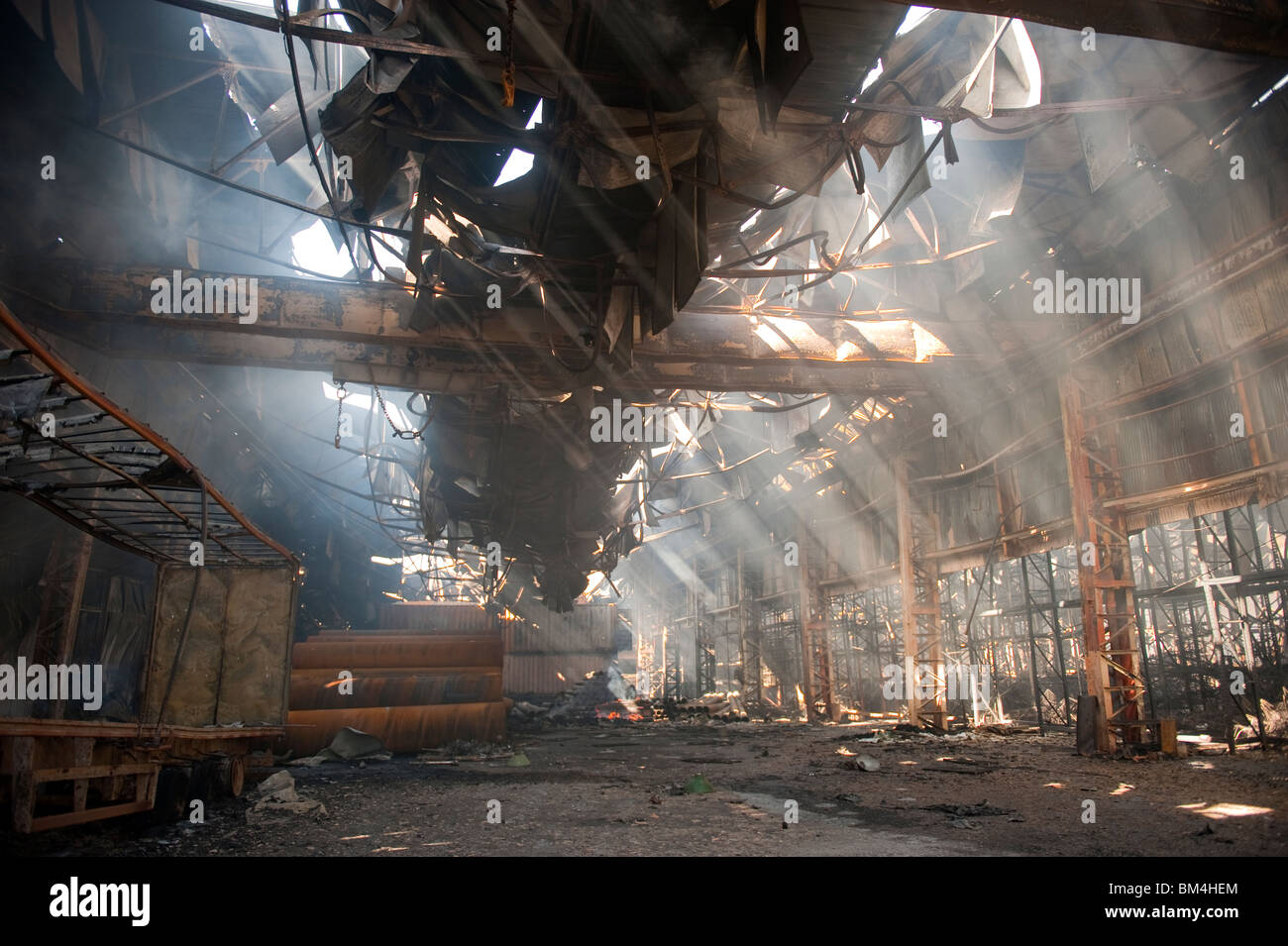 Large factory and warehouse collapsed and smoldering following major ...