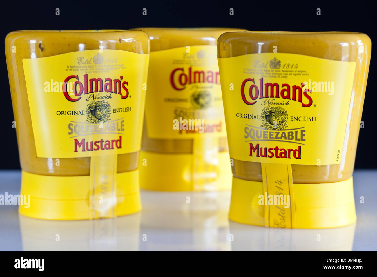 Three containers of Colmans squeezable English mustard Stock Photo - Alamy