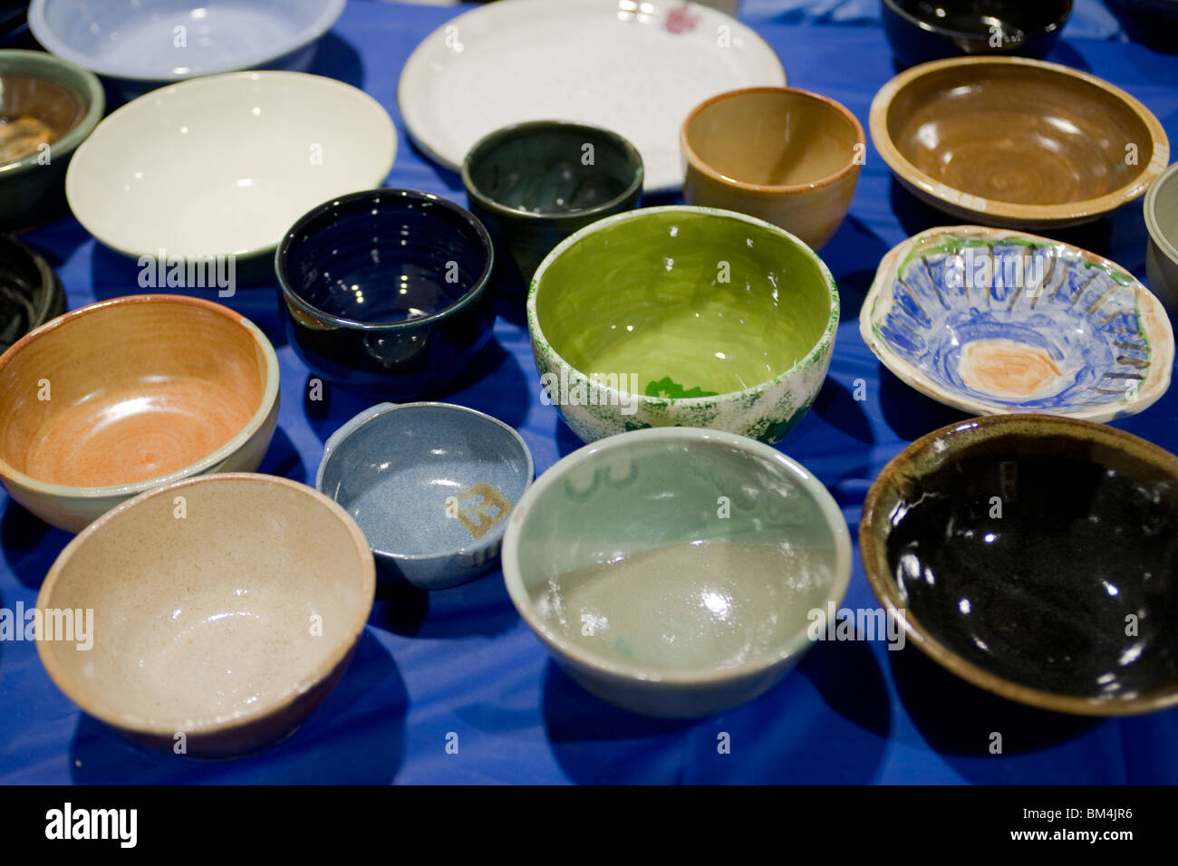 Table full of handmade ceramic bowls Stock Photo - Alamy
