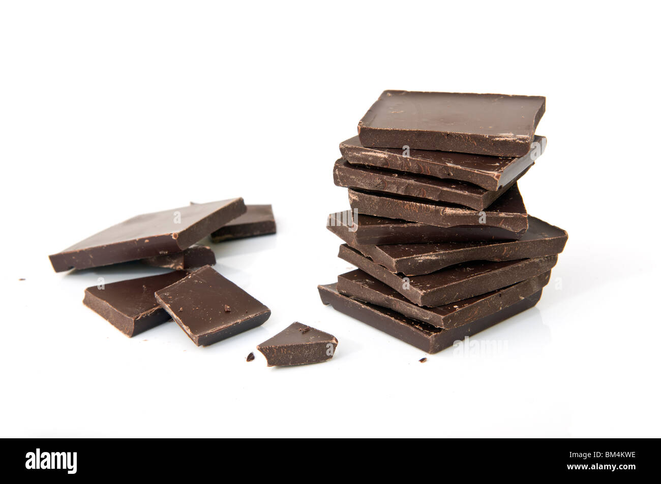 Studio shot of a stack of plain chocolate pieces against a white ...