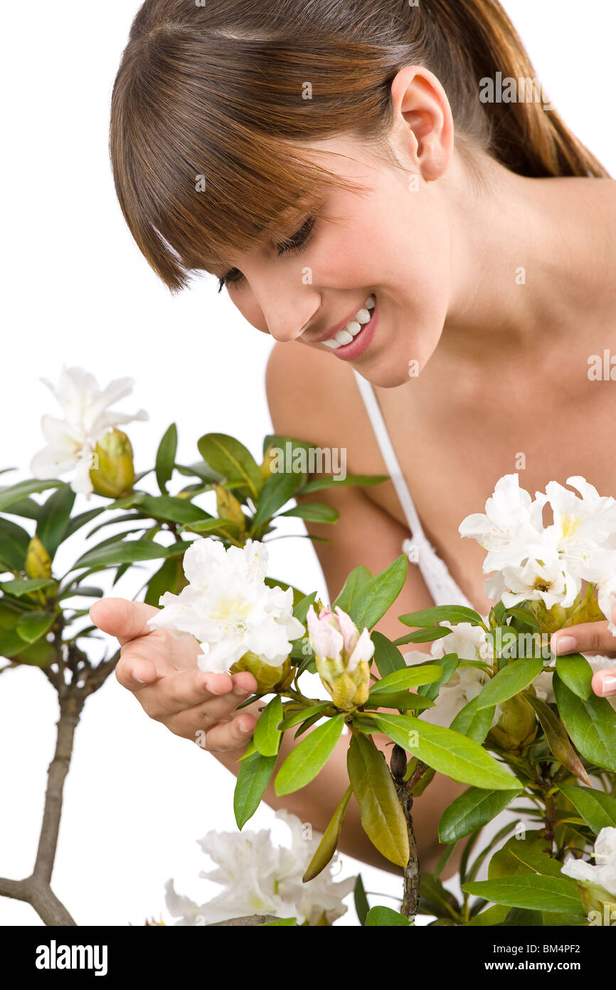 Gardening - Portrait of woman with Rhododendron flower on white ...