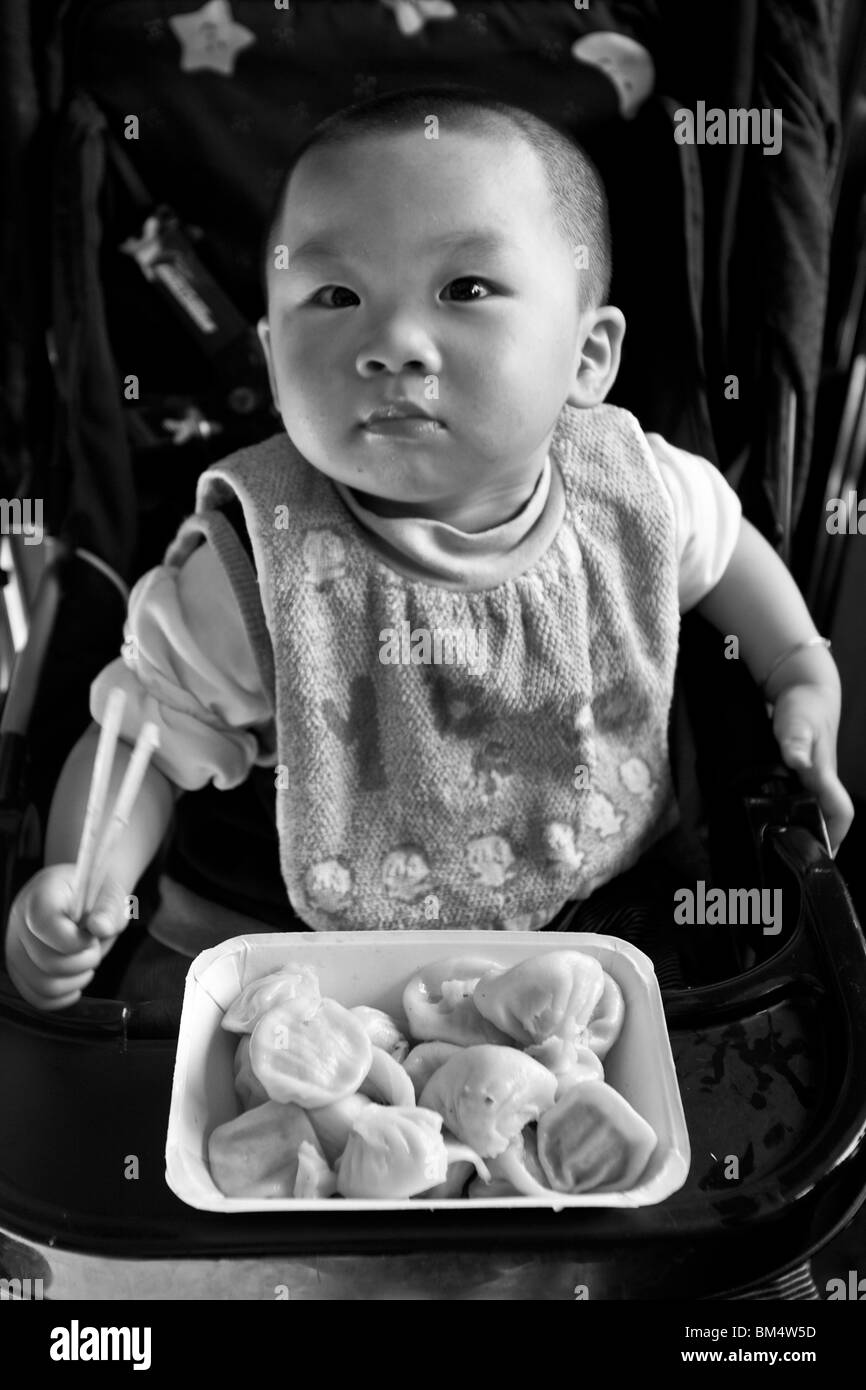 China boy eating with Black and White Stock Photos & Images - Alamy