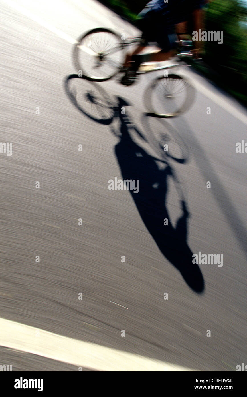 Cyclist and his shadow Stock Photo - Alamy