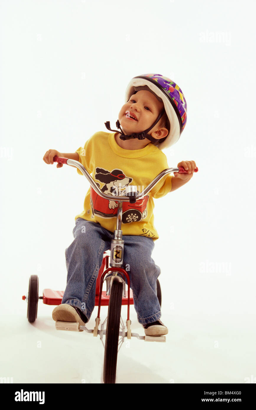 4 year old boy posing on his tricycle Stock Photo - Alamy
