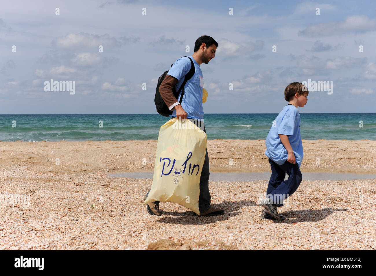Israel Beach cleaning. Volunteers scan a beach collecting garbage Stock ...