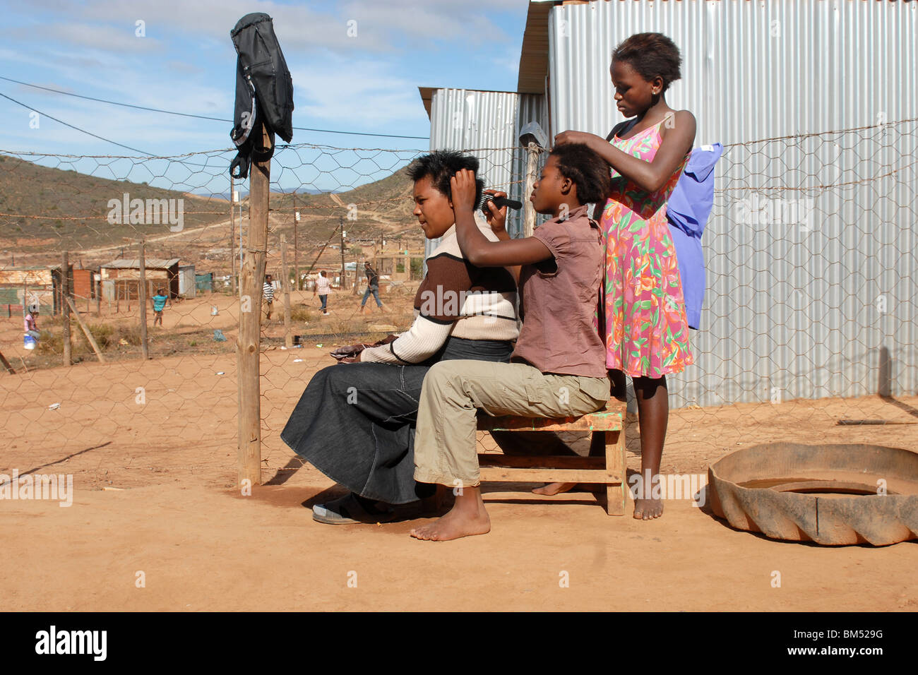 Three woman in front at their shack Stock Photo - Alamy
