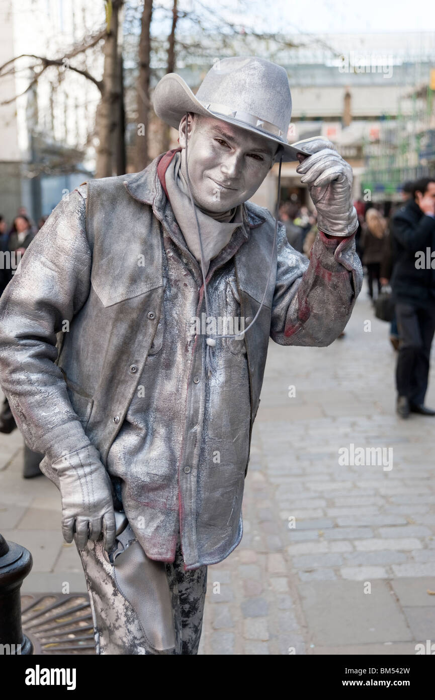 Silver painted human statue of a cowboy in Covent Garden, London ...