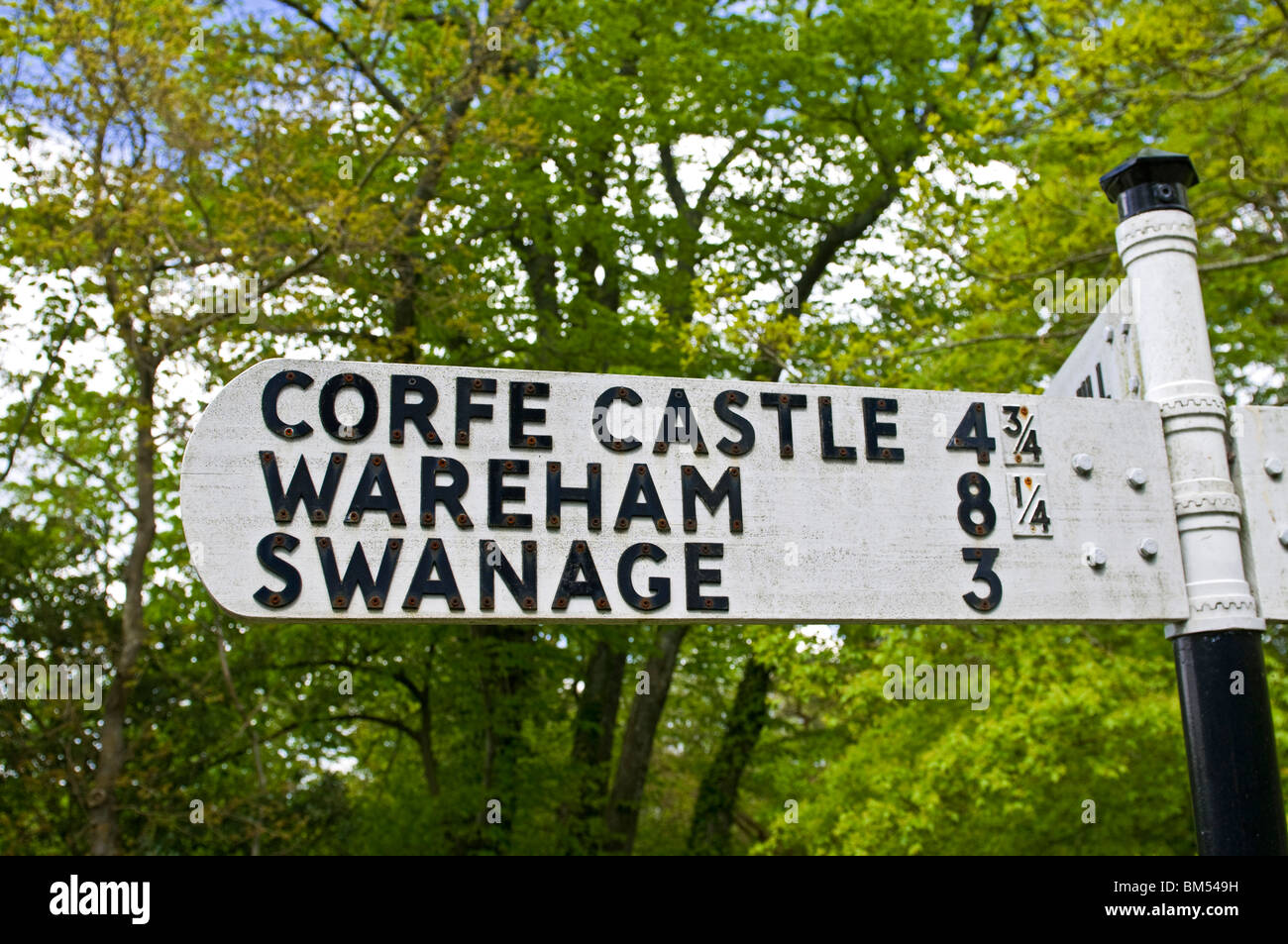 Traditional rural English road sign pointing toward Corfe Castle ...