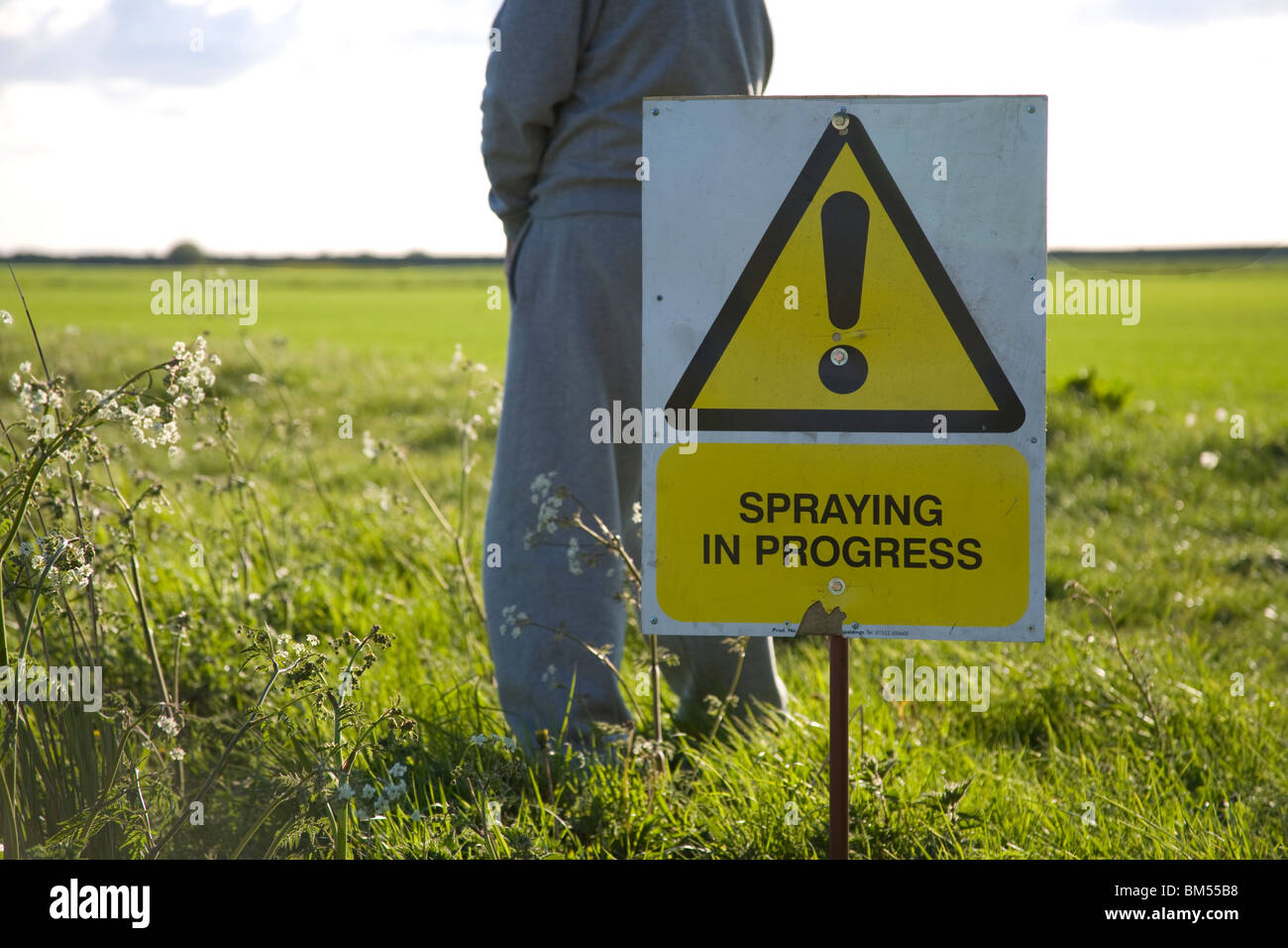 Warning Sign on Farmland Spraying in progress Stock Photo - Alamy