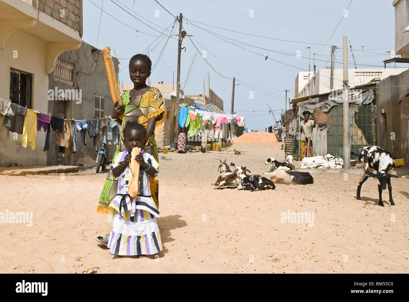 Young girl with a loaf of bread in the streets of Sant Louis, Senegal ...