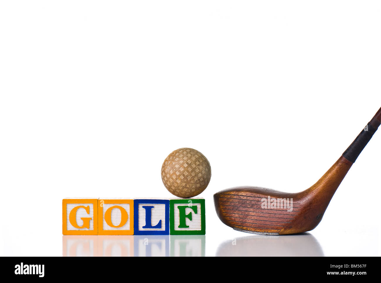 Colorful children's blocks spelling GOLF with antique golf ball and ...