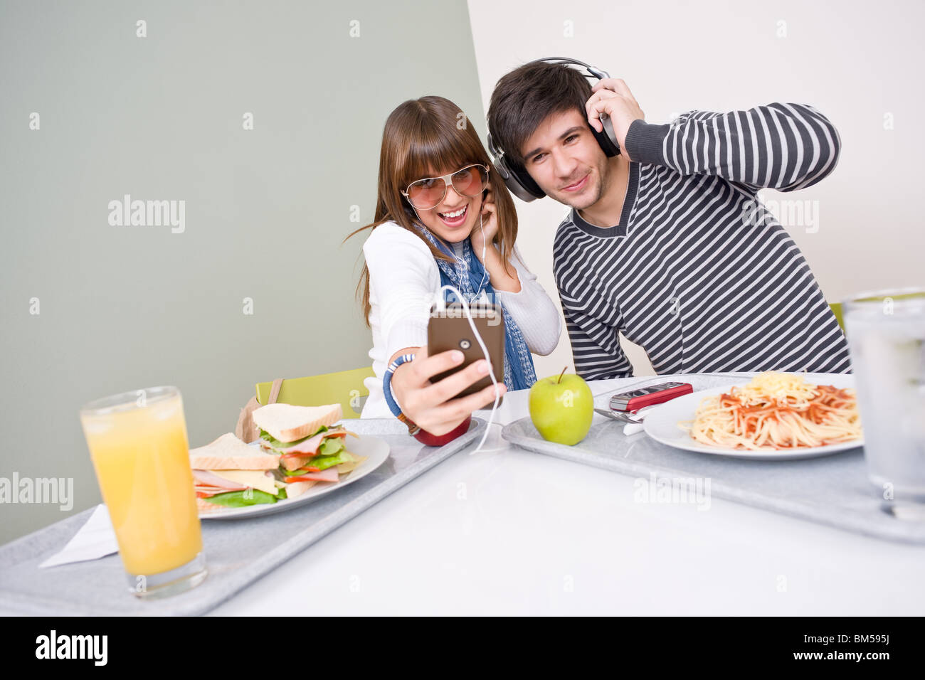 Student cafeteria - teenage couple having fun during lunch break Stock ...