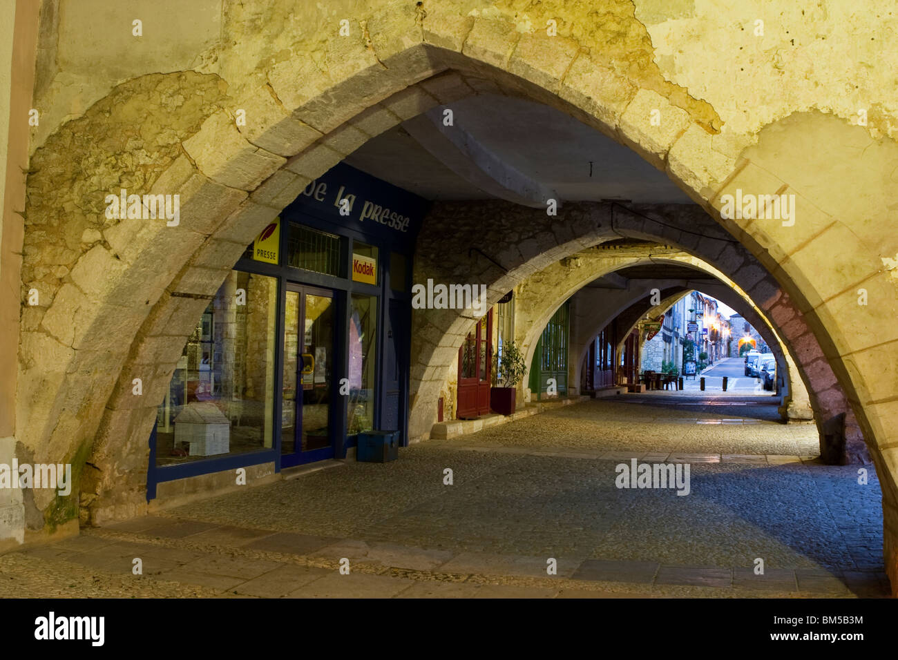 Perspective under the medieval arches of Monpazier, Dordogne, Aquitaine ...