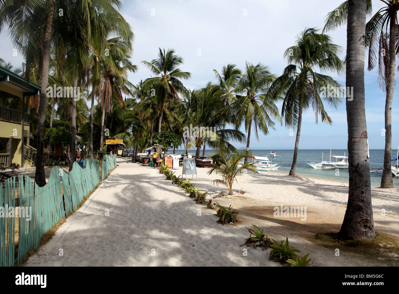 The beach path along Bounty Beach on Malapascua Island, a small island ...