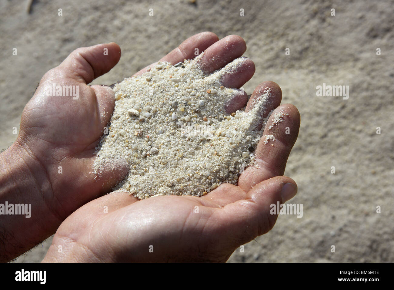 gravel sand in man hands in quarry showing camera Stock Photo - Alamy