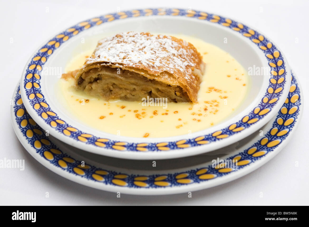Apple Strudel (Apfelstrudel) is served with custard (Vanillesoße) in ...