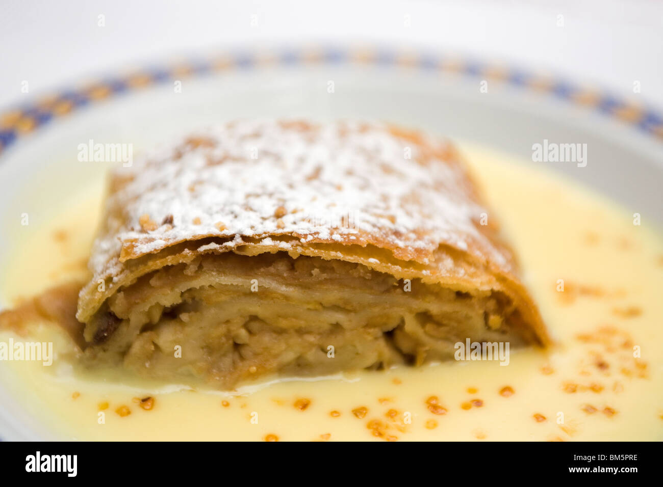 Apple Strudel (Apfelstrudel) is served with custard (Vanillesoße) in ...