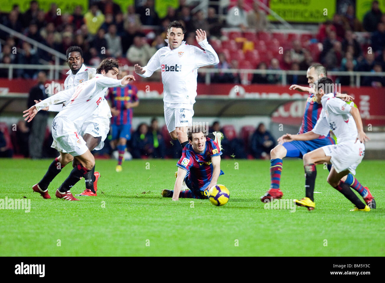 Messi falling down and looking at the ball Stock Photo - Alamy