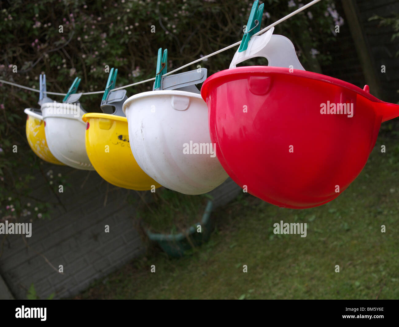 Hard hats on washing line, England, UK Stock Photo - Alamy