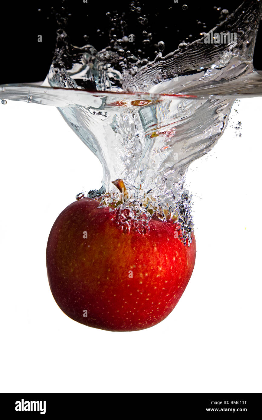 one red apple thrown in water Stock Photo - Alamy