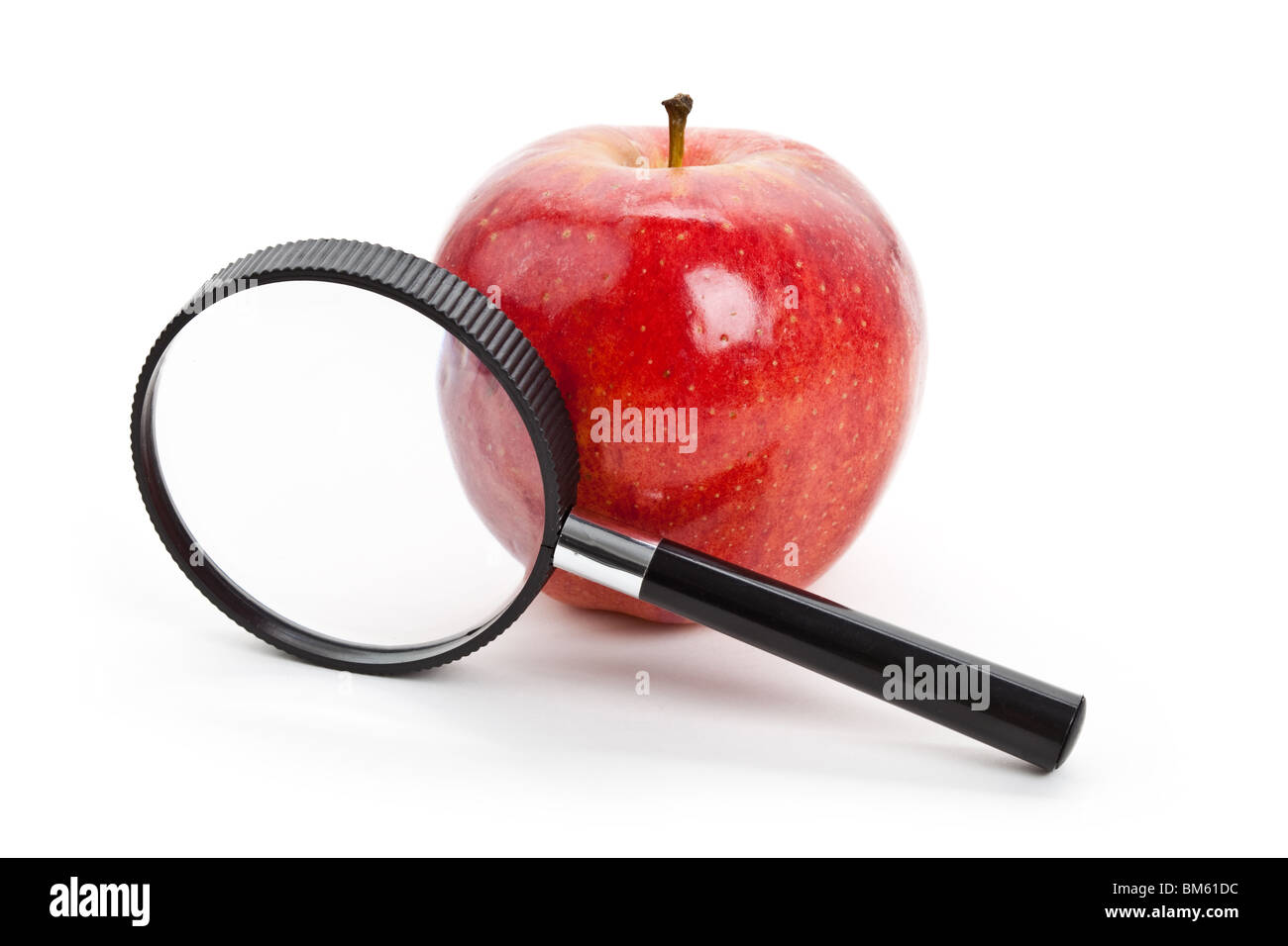 Red apple and Magnifier with white background Stock Photo - Alamy