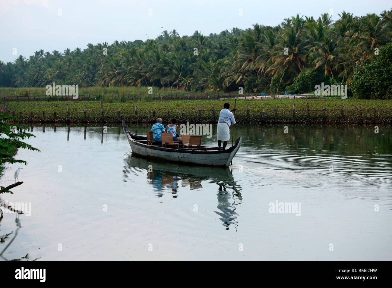 A tourist couple enjoying the boat ride in the backwater of Kerala ...