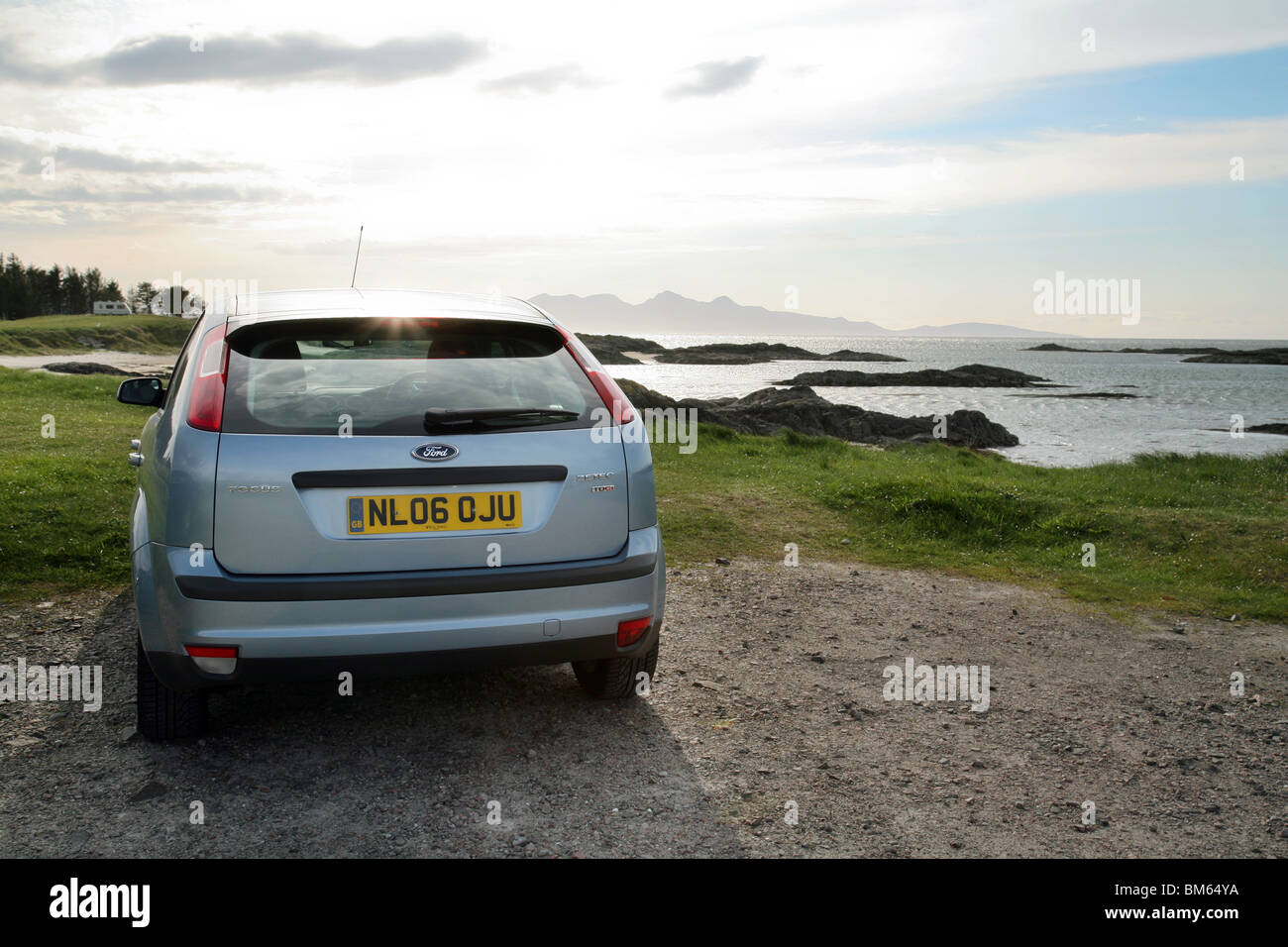 A car parked on the "Road to the Isles", with the Isle of Rum in the ...