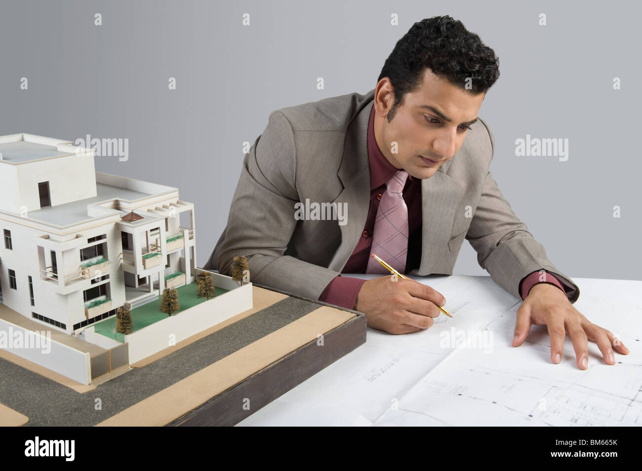 Architect designing a blueprint Stock Photo - Alamy