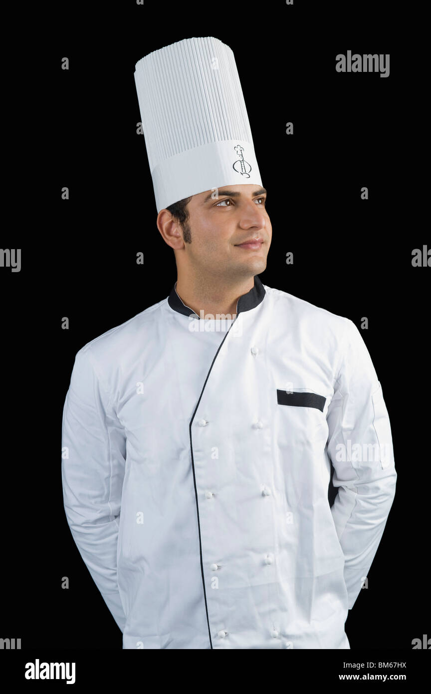 Smiling standing looking away hands behind back hi-res stock ...