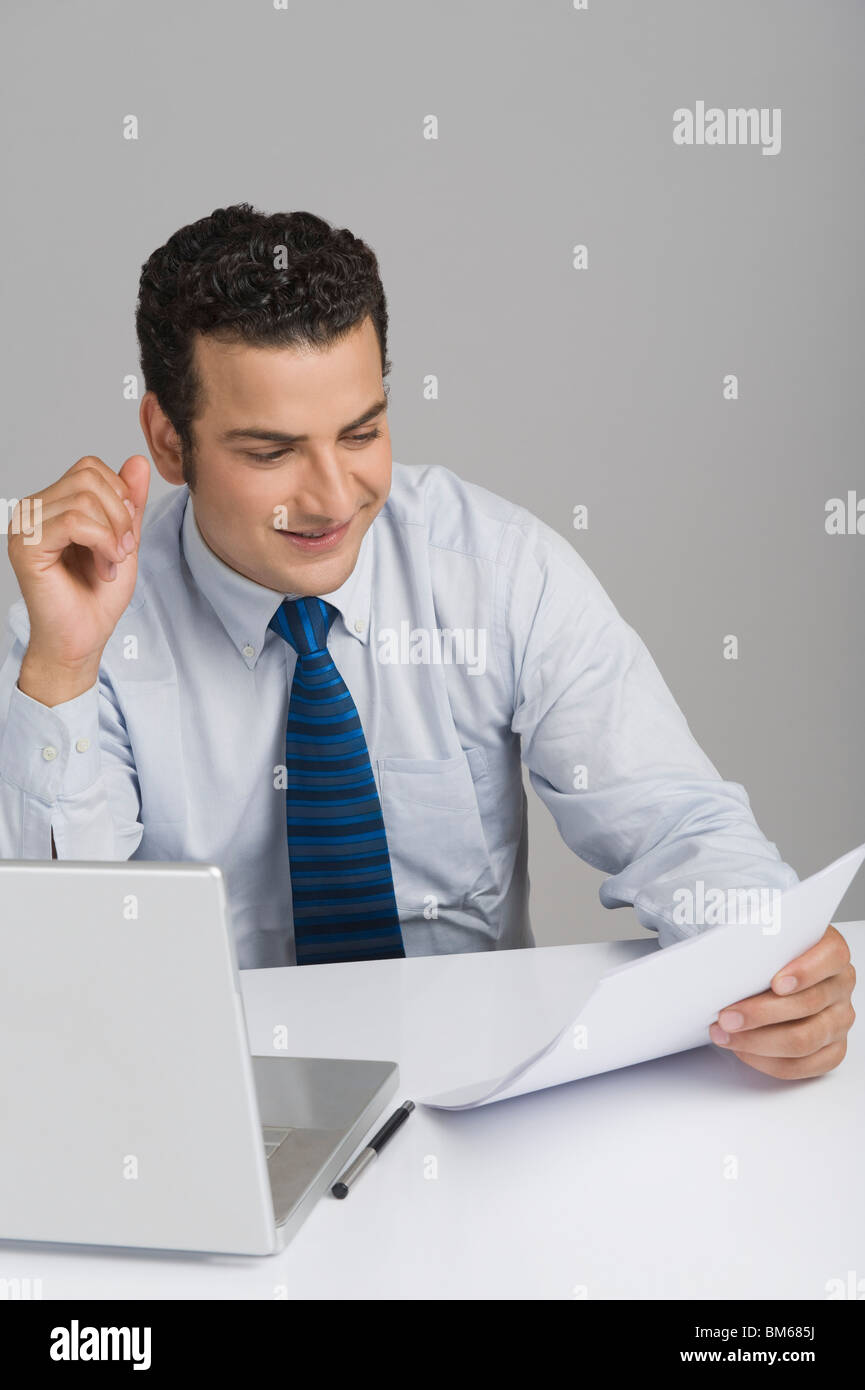 Businessman reading a document Stock Photo - Alamy