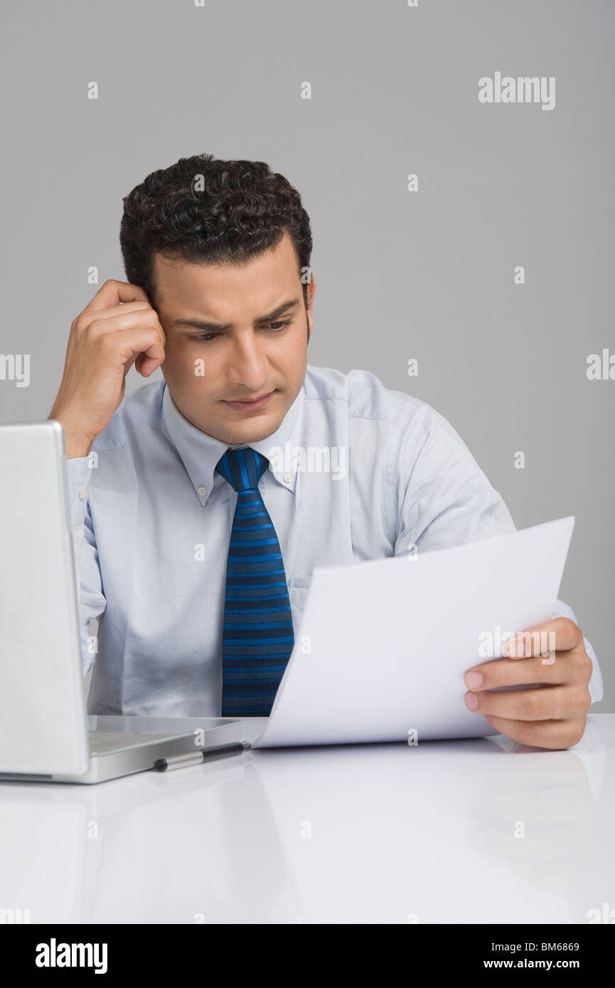 Businessman reading a document Stock Photo - Alamy