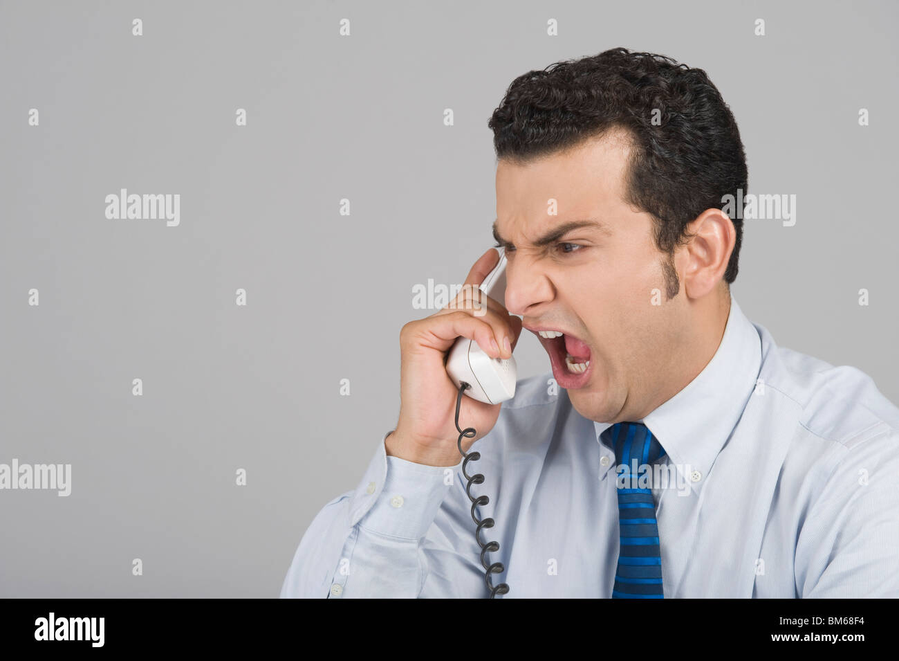 Businessman screaming down telephone hi-res stock photography and ...