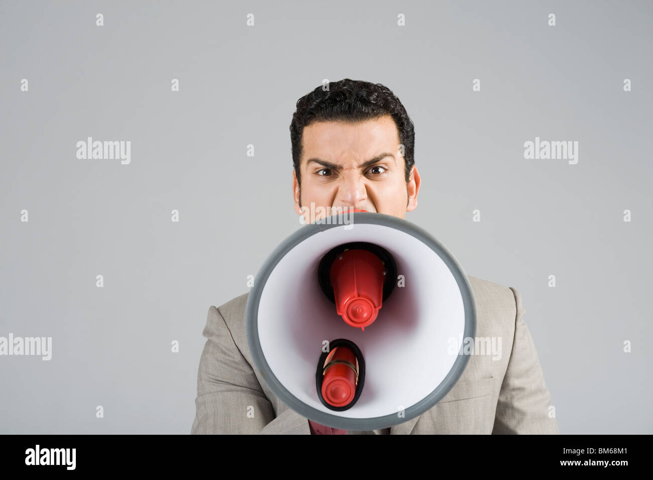 Businessman shouting into a megaphone Stock Photo - Alamy