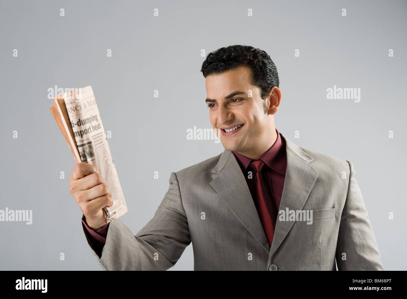 Businessman holding a newspaper Stock Photo - Alamy