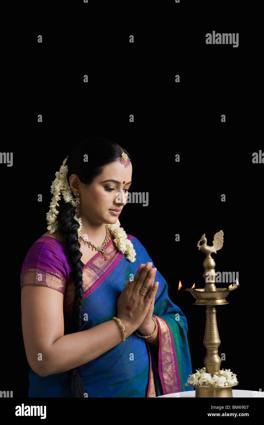 Woman praying oil lamp in hi-res stock photography and images - Alamy