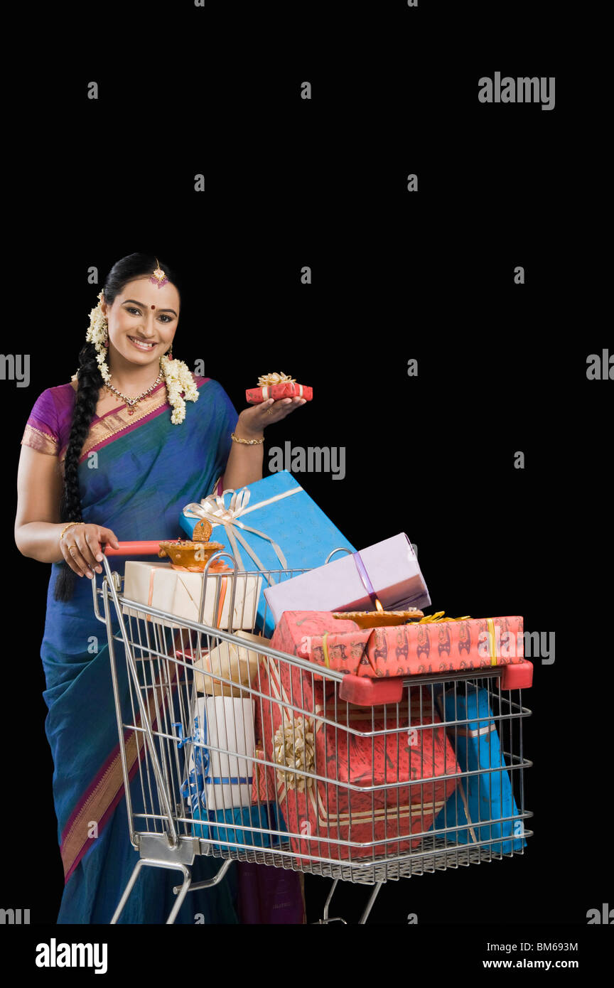 Woman carrying Diwali gifts in a shopping cart Stock Photo - Alamy