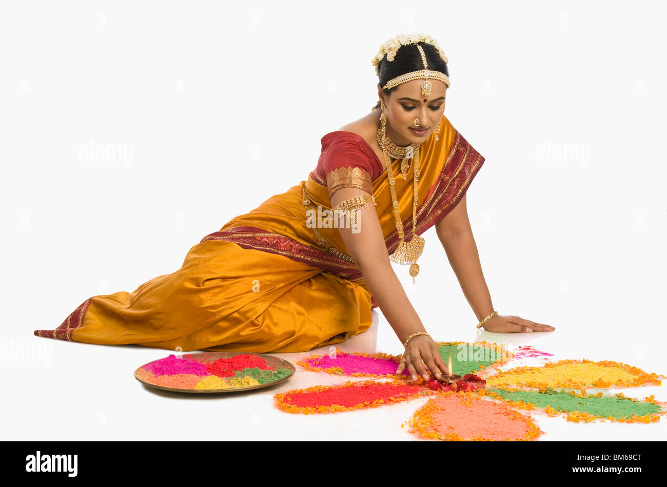 South Indian woman making rangoli Stock Photo - Alamy