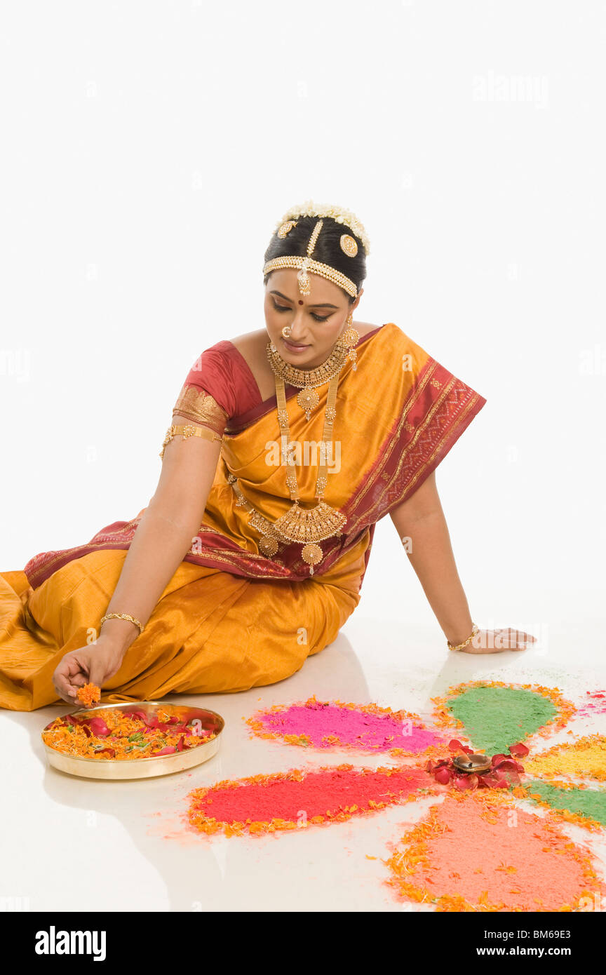South Indian woman making rangoli Stock Photo - Alamy