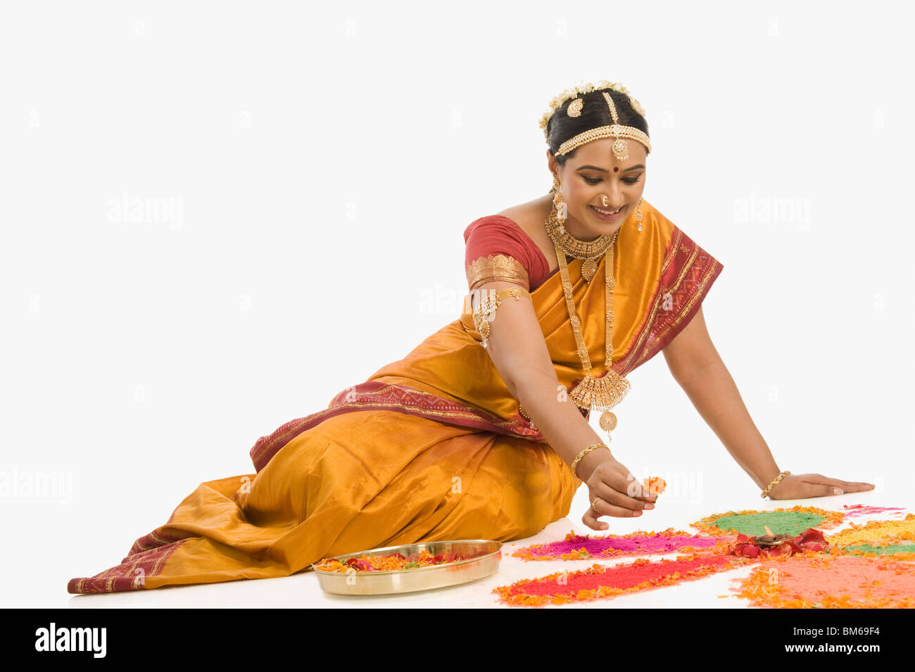 South Indian woman making rangoli Stock Photo - Alamy