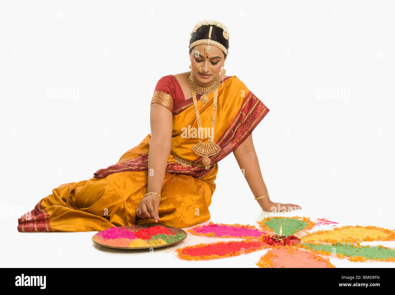 South Indian woman making rangoli Stock Photo - Alamy