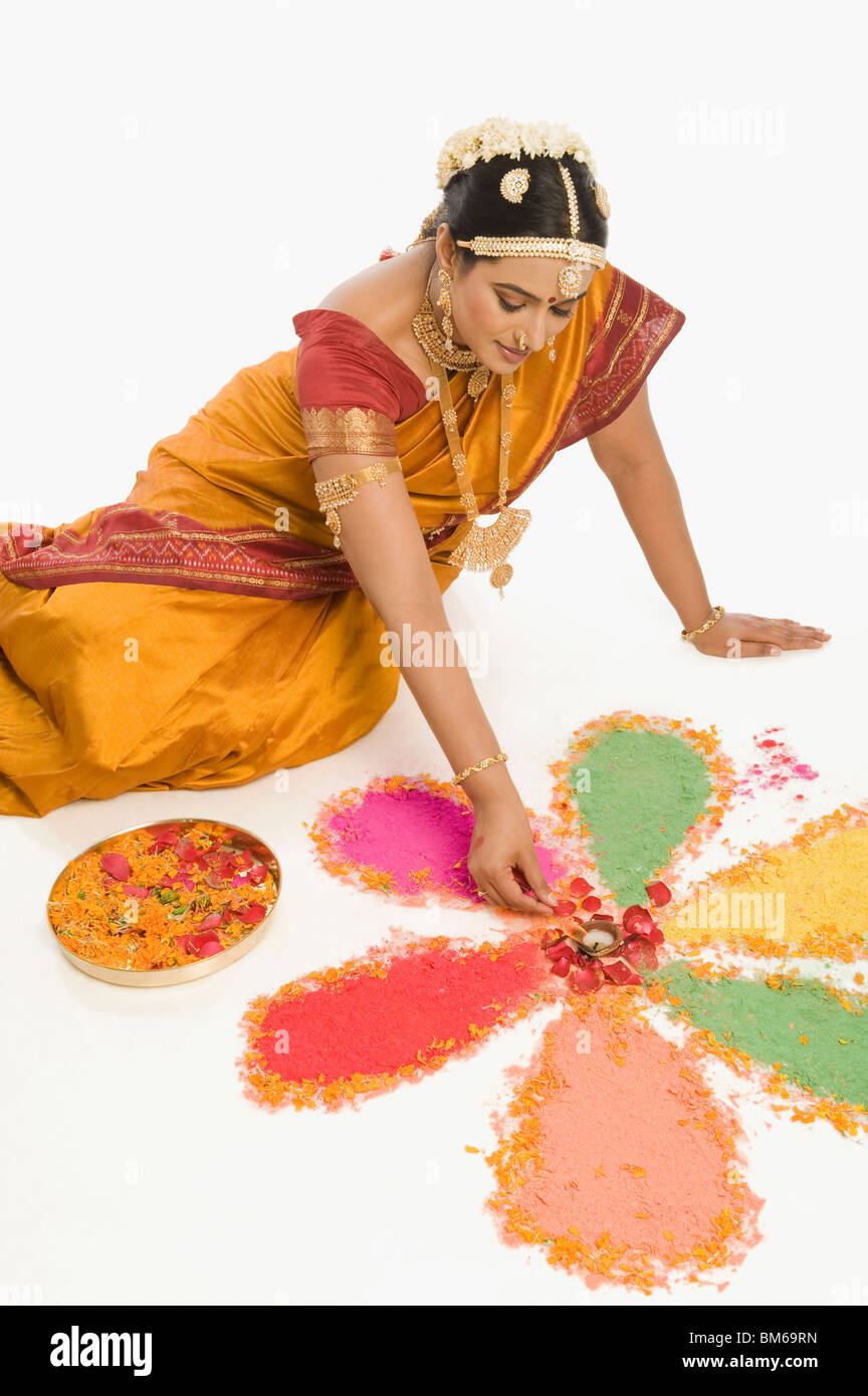 South Indian woman making rangoli Stock Photo - Alamy