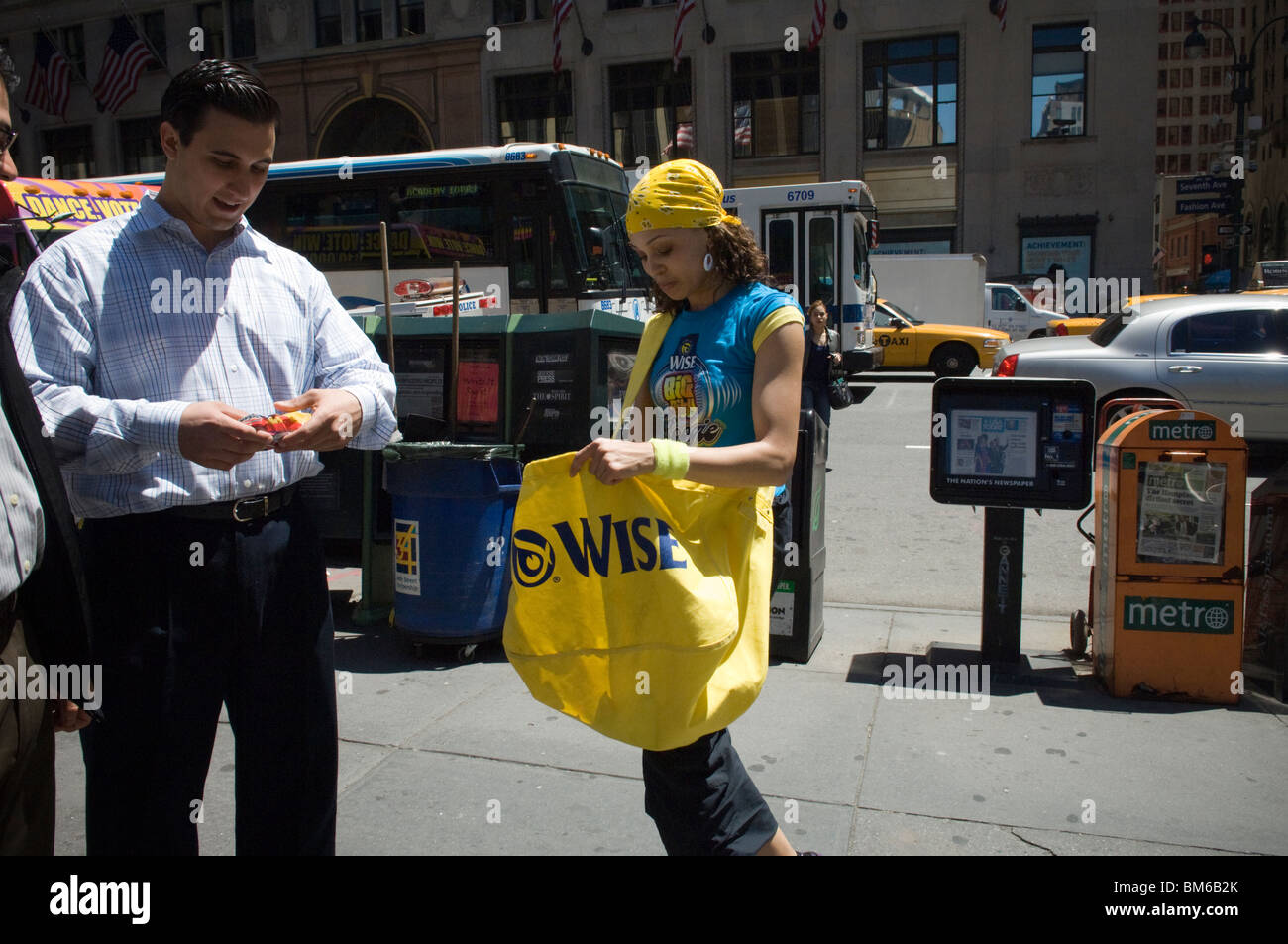 A woman passes out samples of a Wise potato chip outside of Madison ...