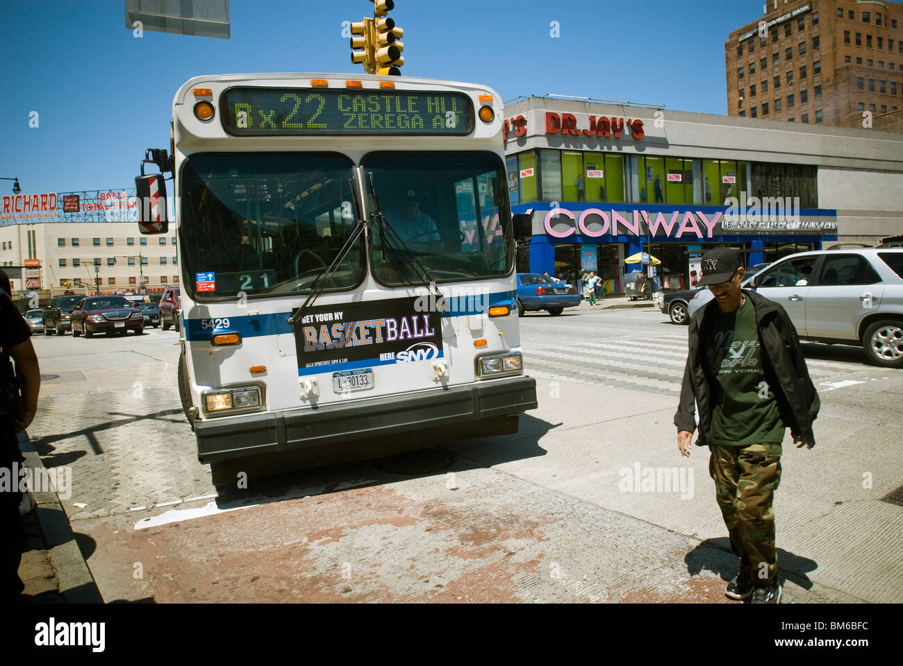 A New York City bus turns onto Fordham Road in the borough of the Bronx ...