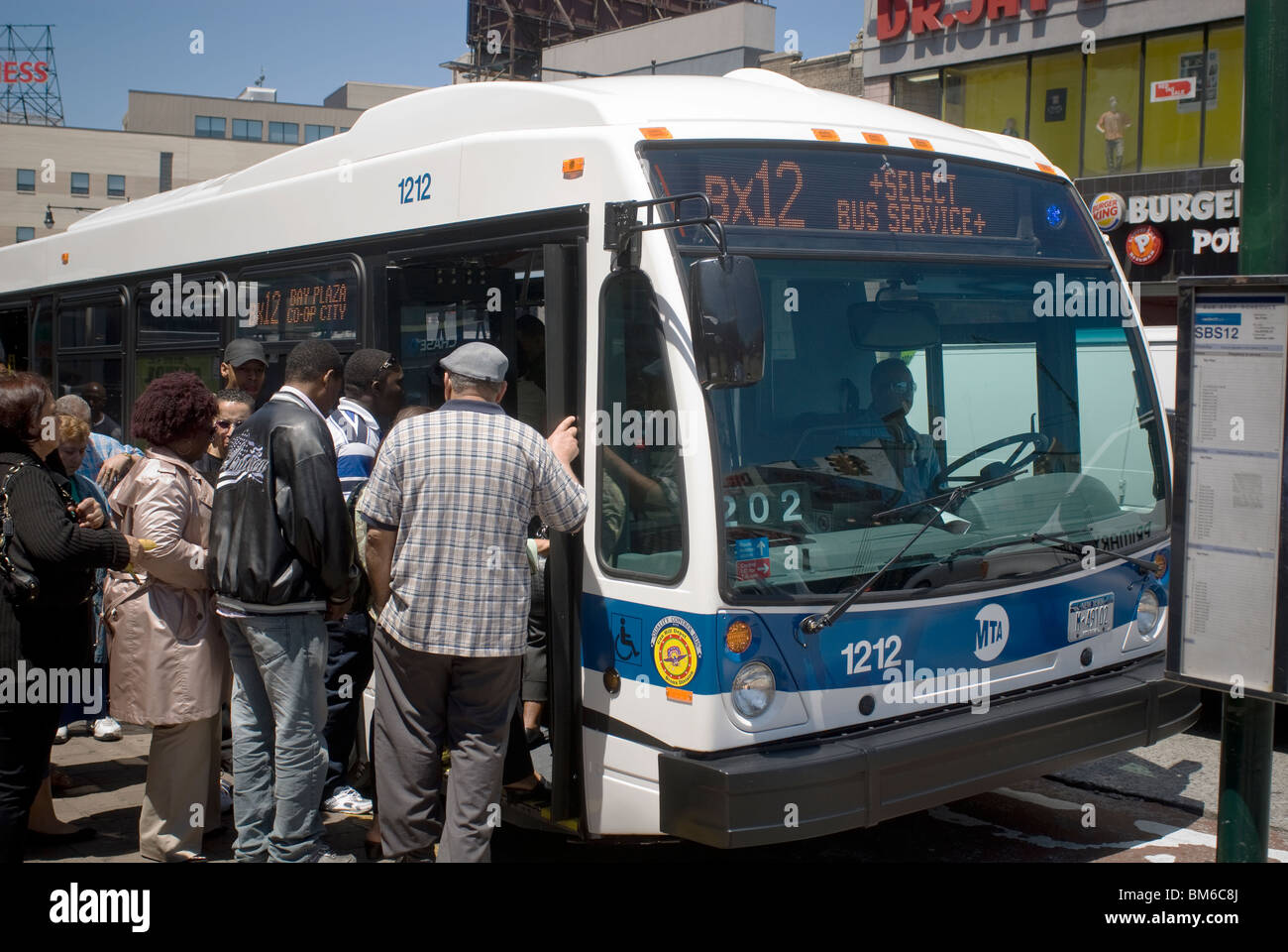 Commuters board a Select Bus Service bus in the New York borough of the ...